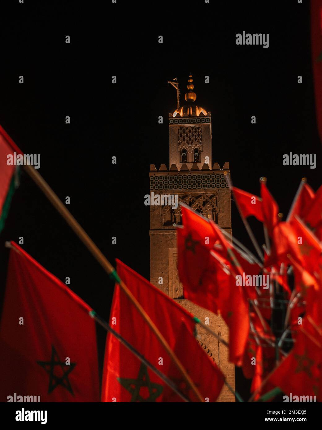 A vertical shot of multiple Moroccan flags on the background of the ...