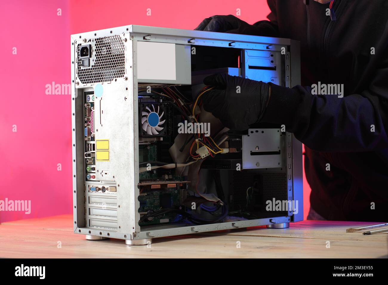 disassembly of an old desktop computer by a person on a table and a ...