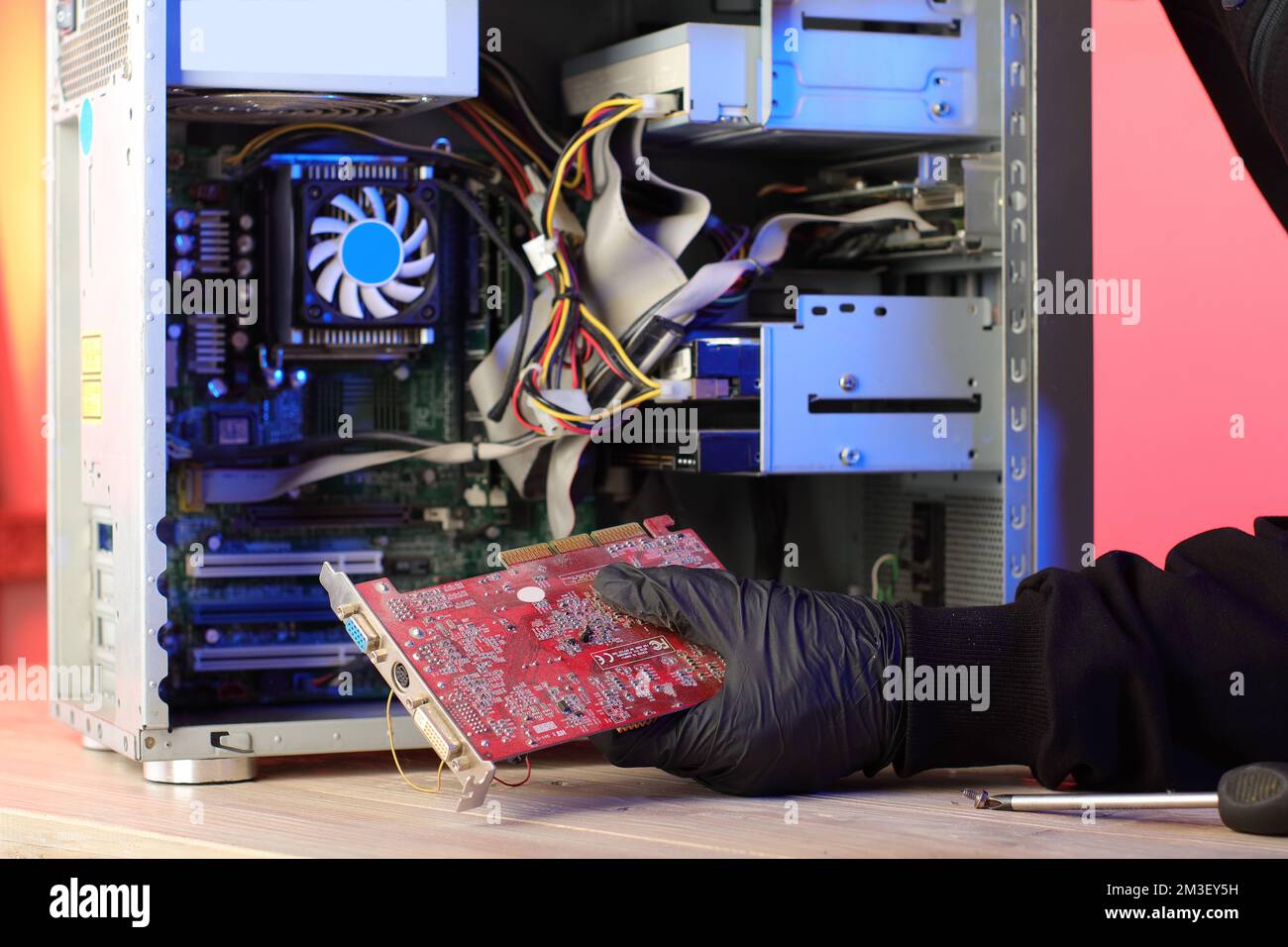 disassembly of a graphics card from an old computer by a person on a ...