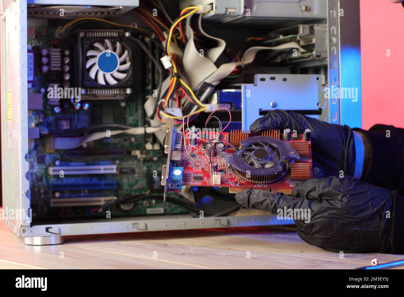 disassembly of a graphics card from an old computer by a person on a ...