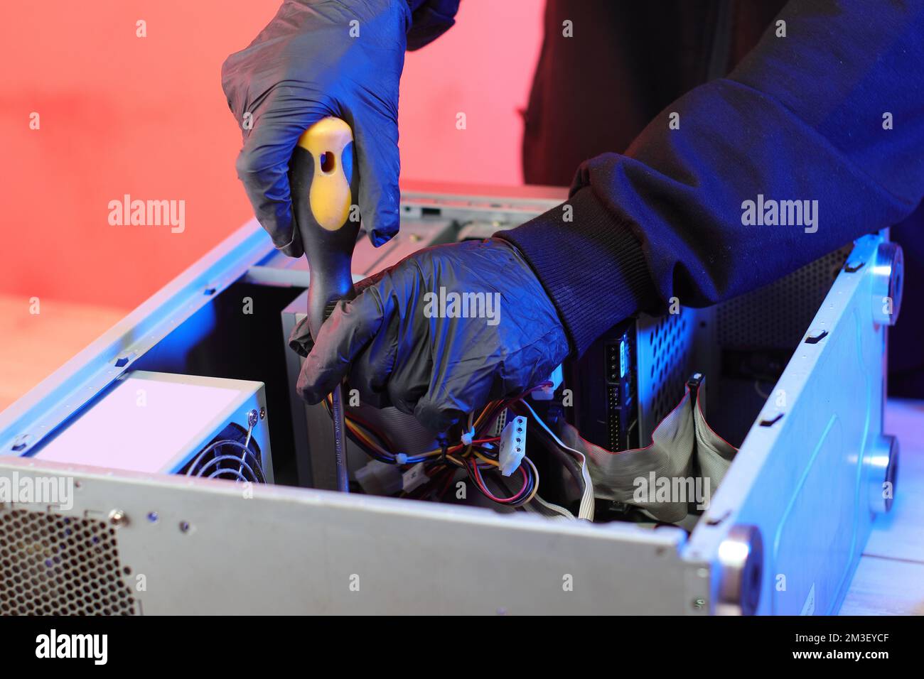 disassembly of an old desktop computer on a table and a pink background ...