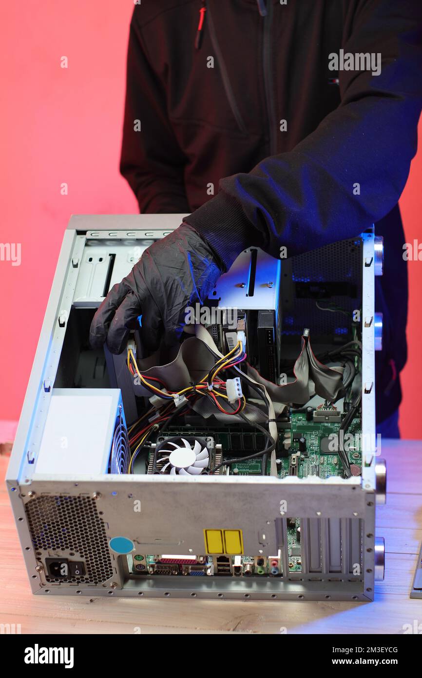 disassembly of an old desktop computer on a table and a pink background ...