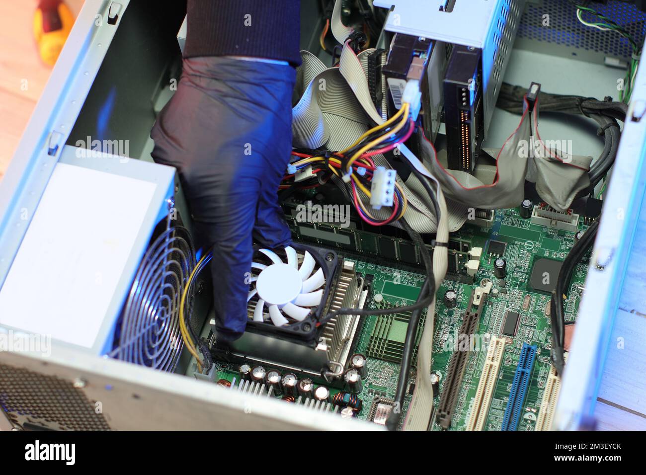 disassembly of an old desktop computer on a table and a pink background ...