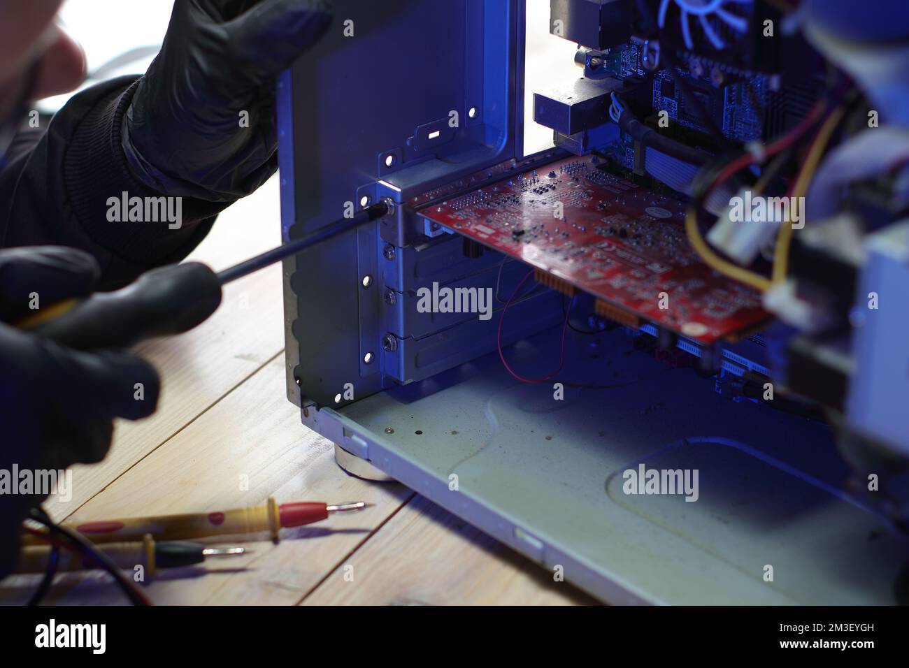 inserting an old graphics card into a computer on the table Stock Photo ...