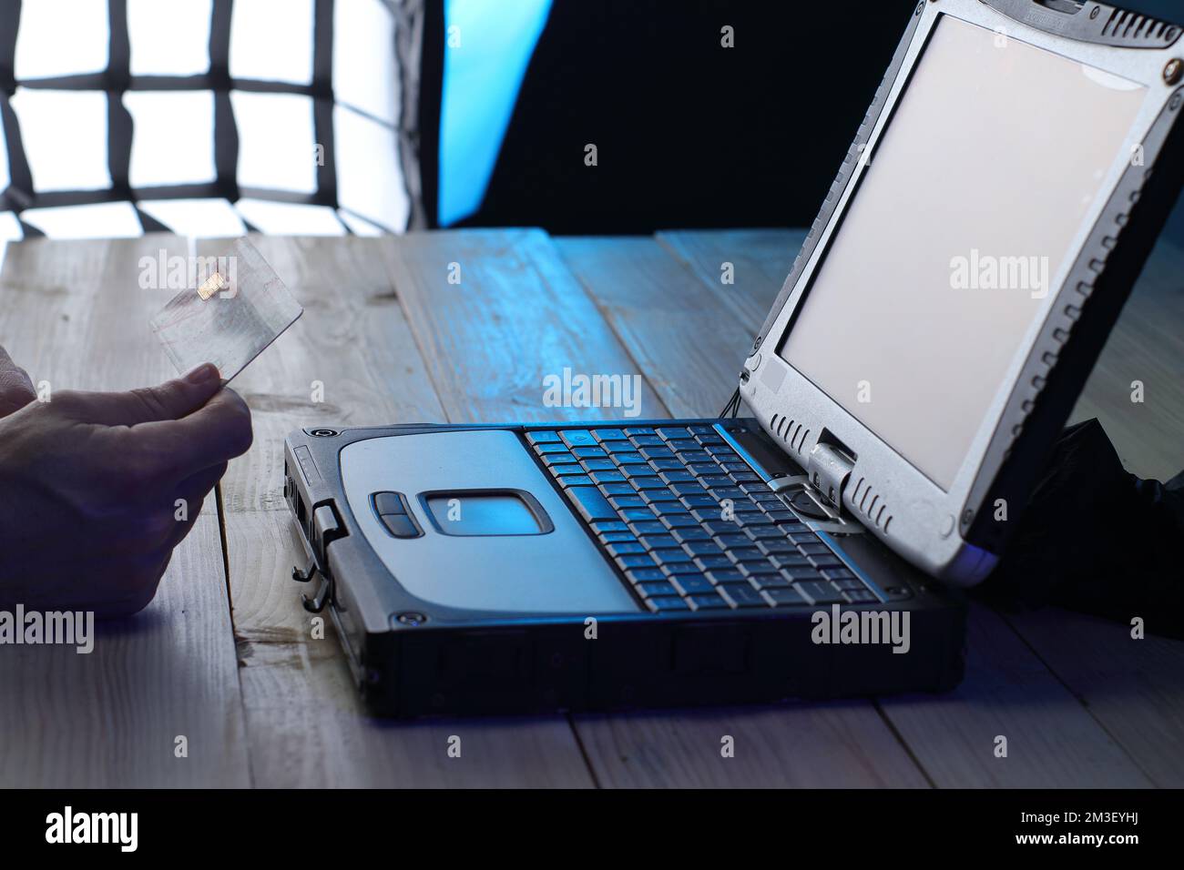 typing data into computer from payment card on table and colored ...