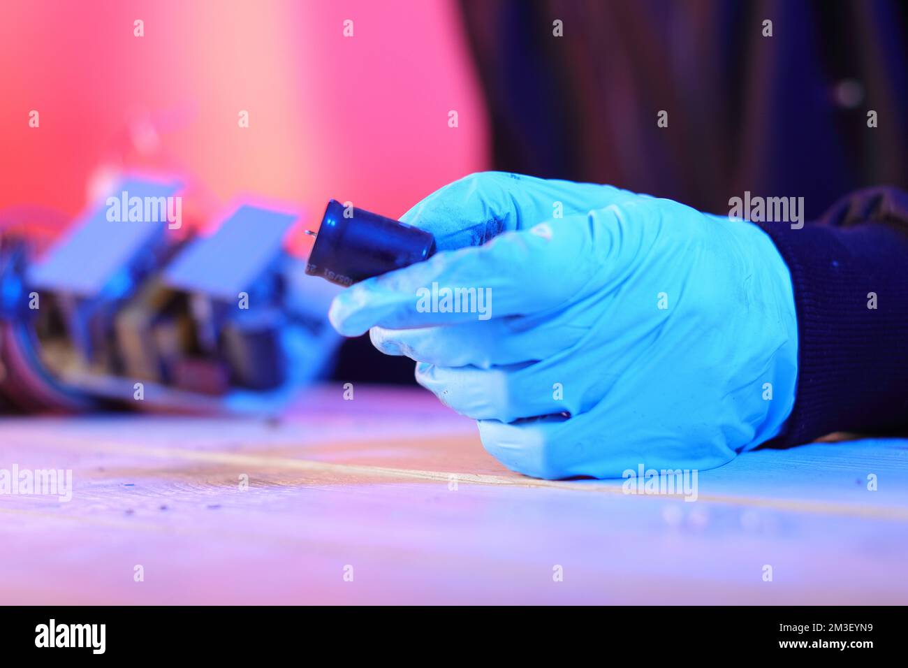 electric capacitor from the computer power supply in the hand on a ...