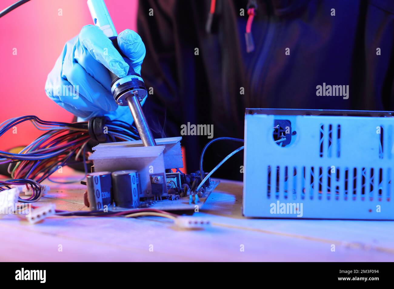 disassembly of a computer power supply on a table by a person and a ...