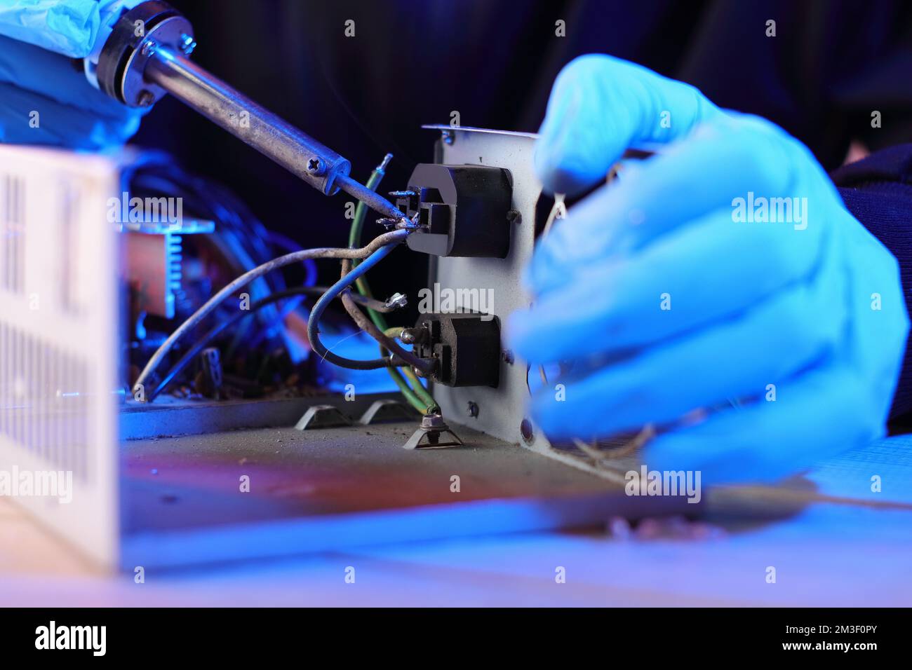 disassembly of a computer power supply on a table by a person and a ...