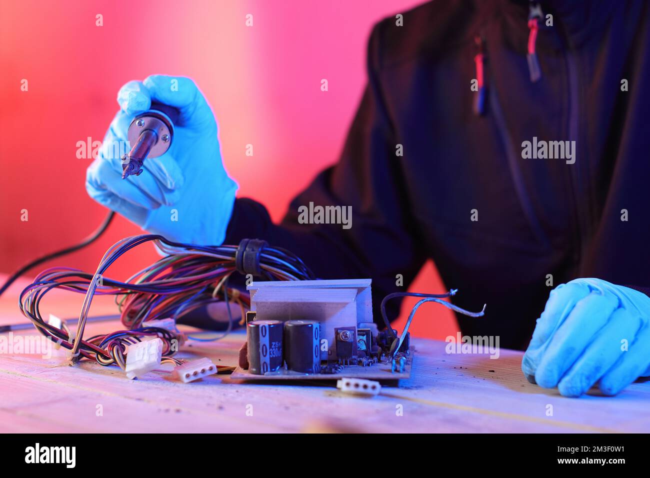 disassembly of a computer power supply on a table by a person and a ...