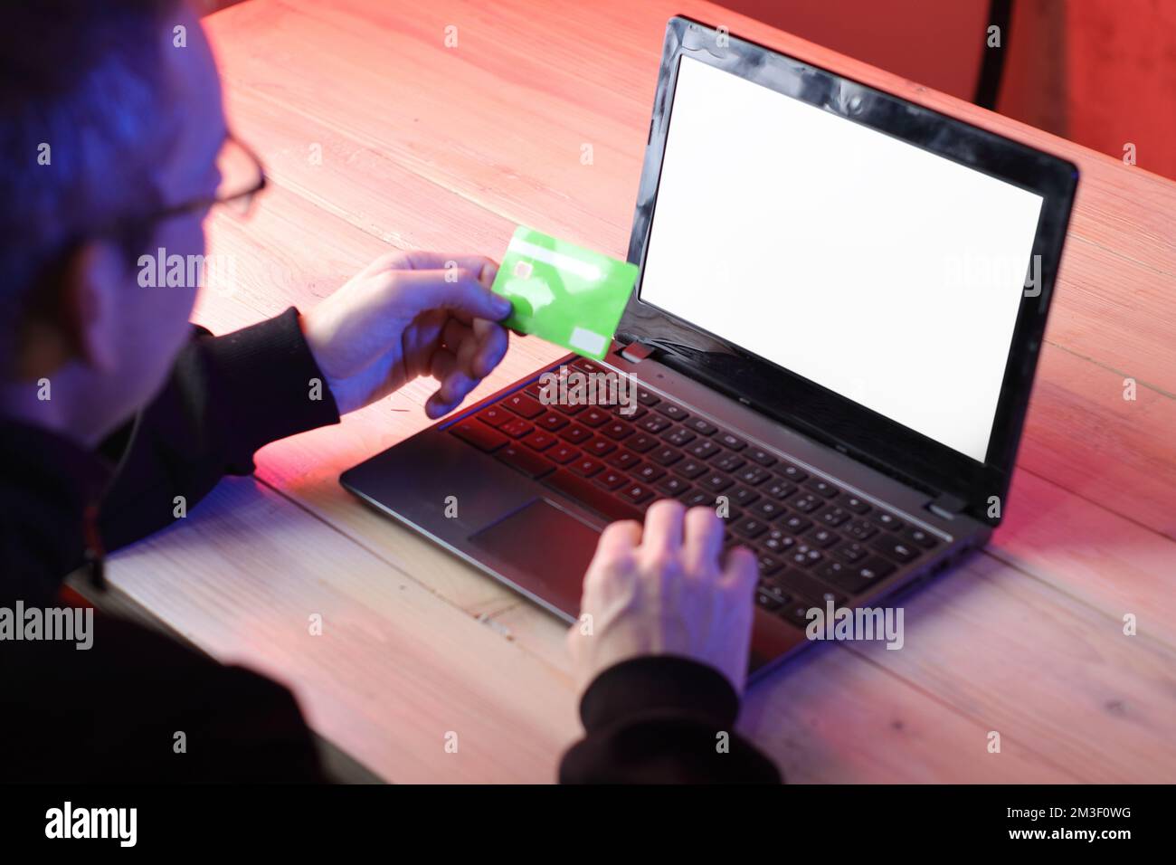 typing data into computer from payment card on table and colored ...