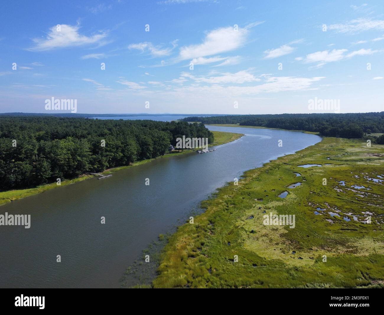 A breathtaking view of a river flowing through the dense green forests ...