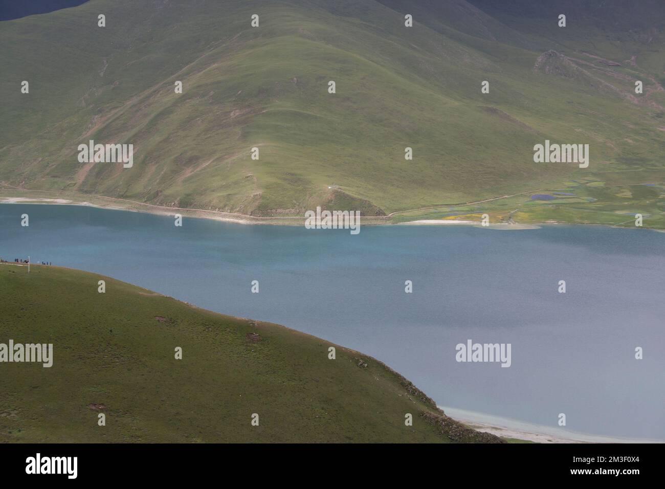 An aerial shot of a water reservoir in front of a mountainside during ...