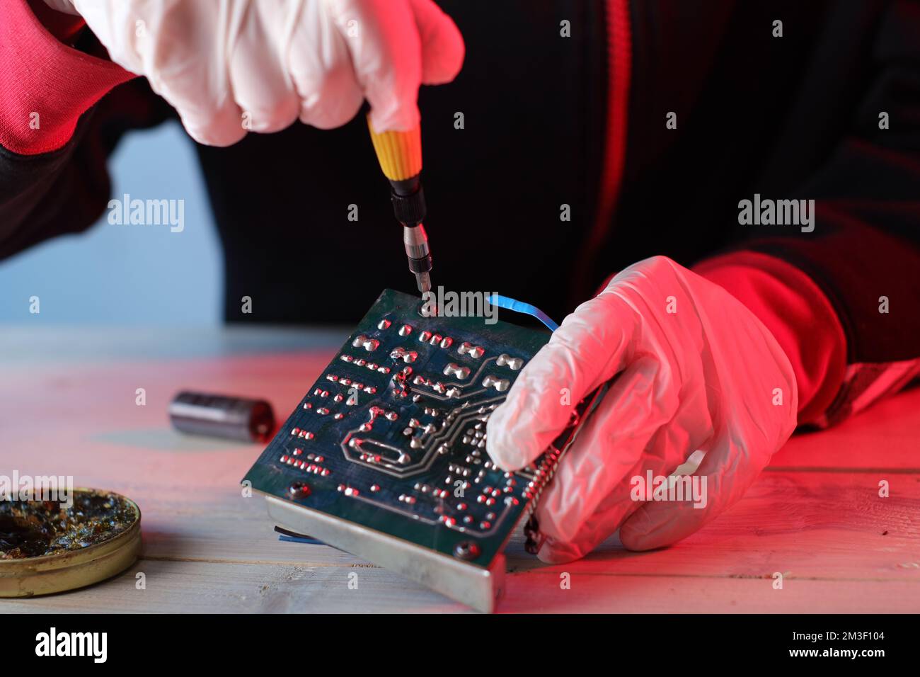 unscrewing the screws from the printed circuit board by a person Stock ...