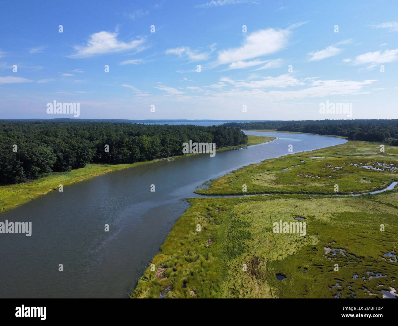 A breathtaking view of a river flowing through the dense green forests ...