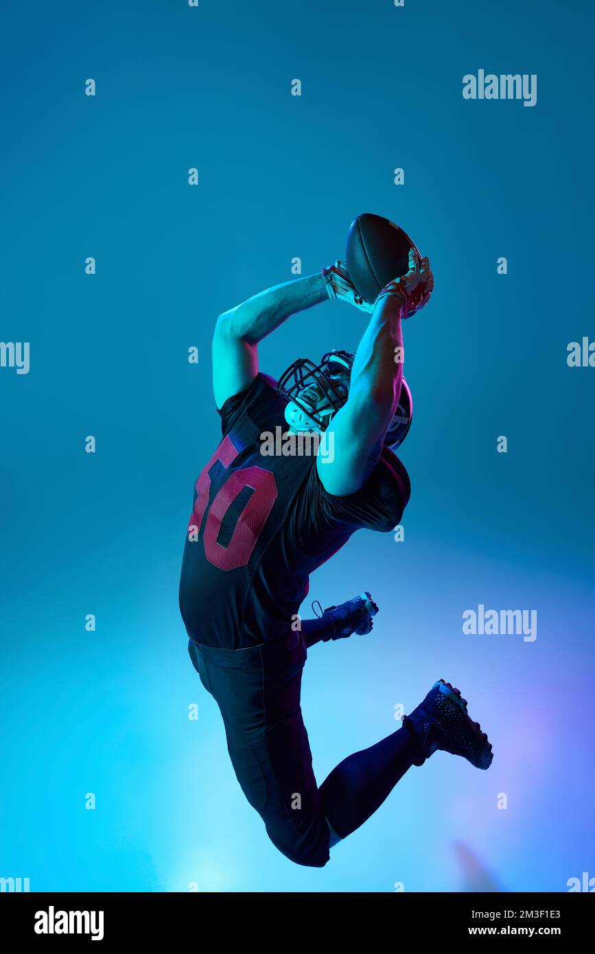 Jump. Aerial view of american football player in sports uniform and ...