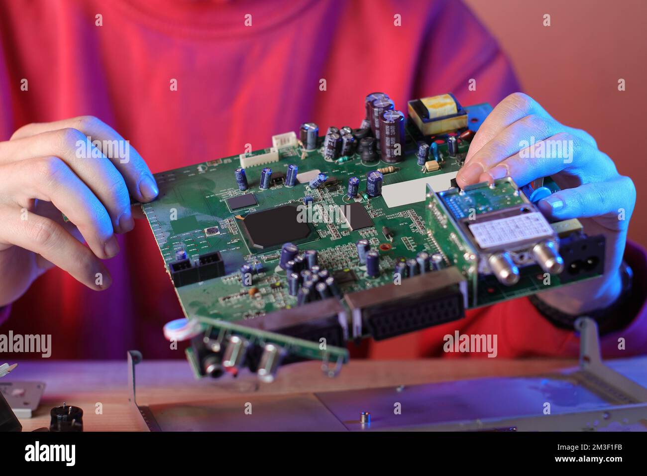 star satellite tuner motherboard in disassembly on table by person ...