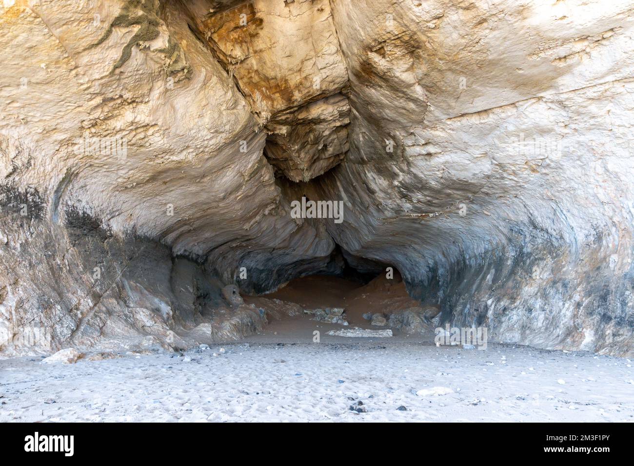 The view out of one of the many seaside caves at the beach of Cala Luna ...