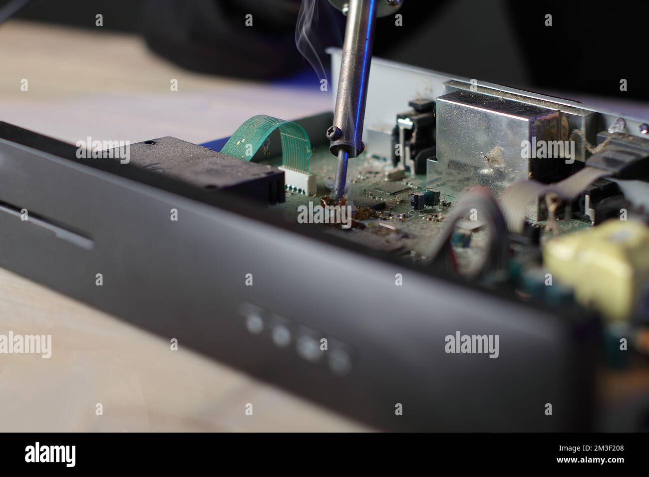 repair of an old satellite tuner by person on the table and gray ...