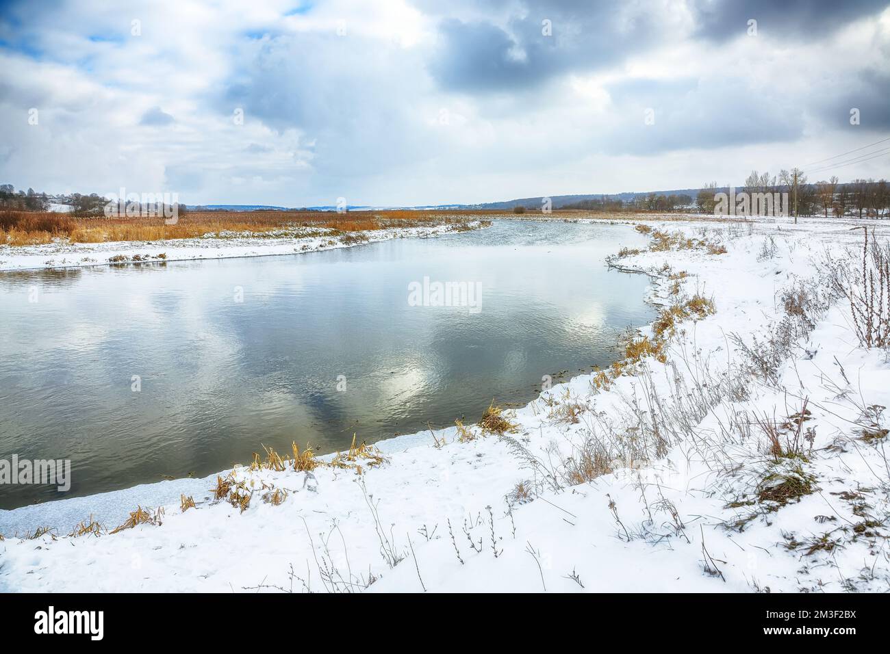 Winter landscape by a river during sunset. Beautiful Winter landscape ...