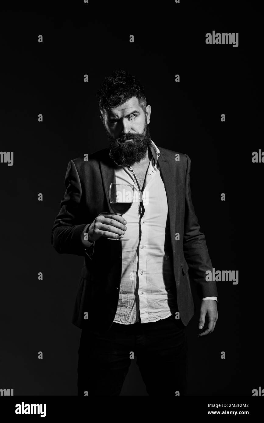 Sommelier with beard on burgundy background. Man in suit toasting Stock ...