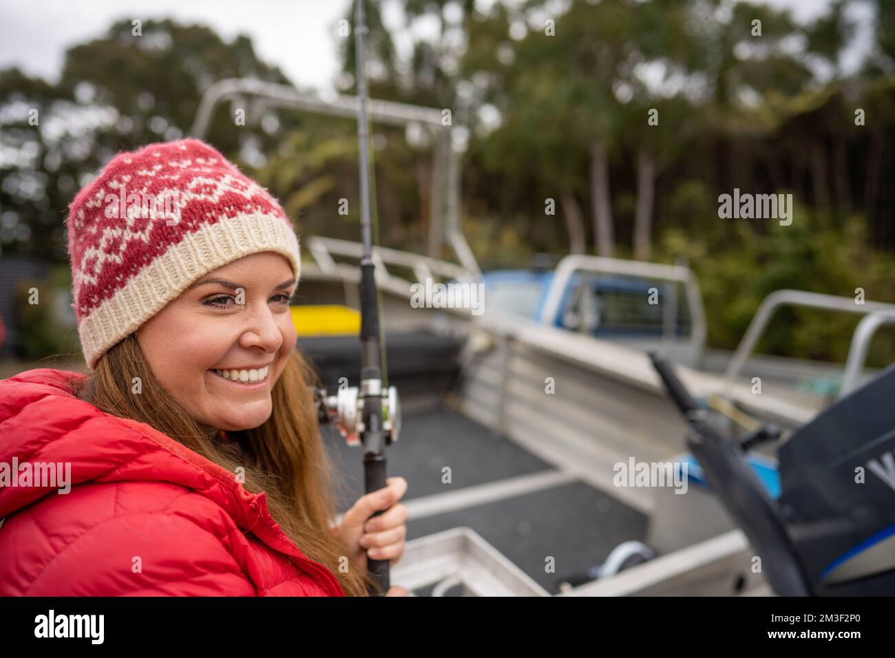model girl fishing in a boat in summer in australia Stock Photo - Alamy
