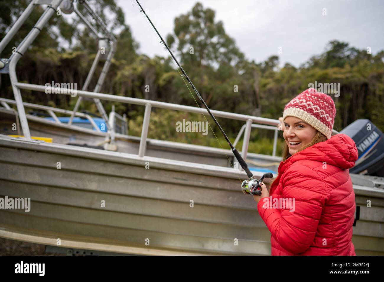 model girl fishing in a boat in summer in australia Stock Photo - Alamy