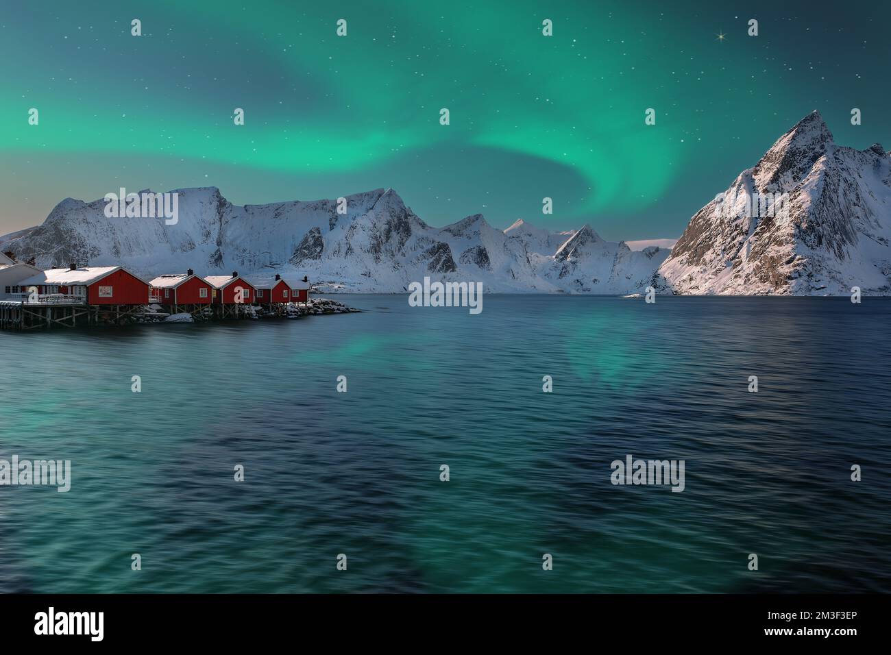 Traditional Norwegian red wooden houses (rorbuer) on the shore of ...