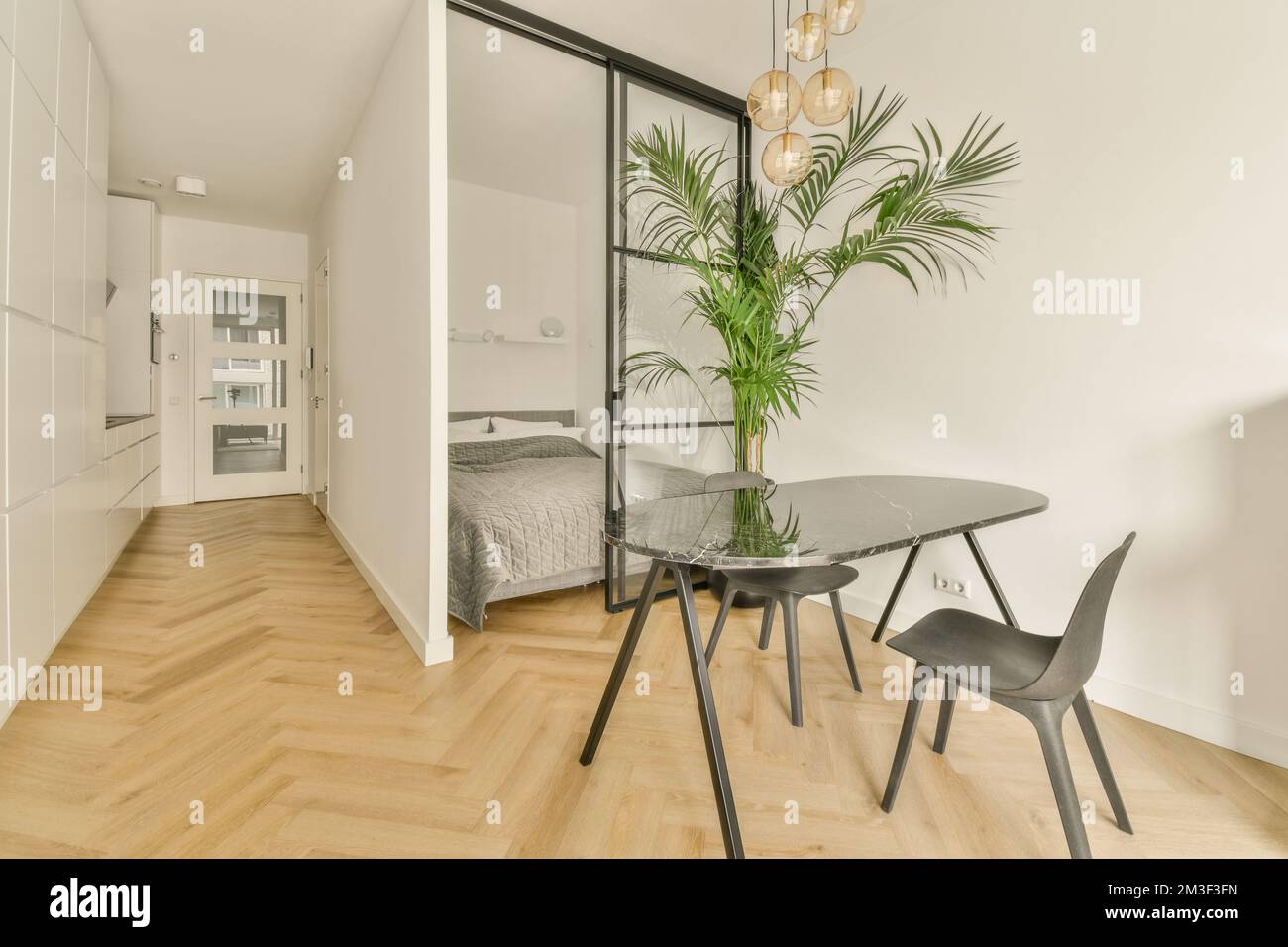 a dining table and chairs in a room with white walls, wood flooring and ...