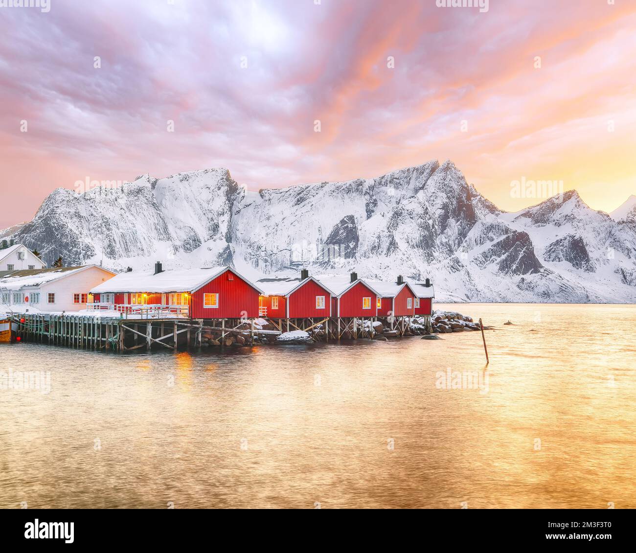 Traditional Norwegian red wooden houses (rorbuer) on the shore of ...