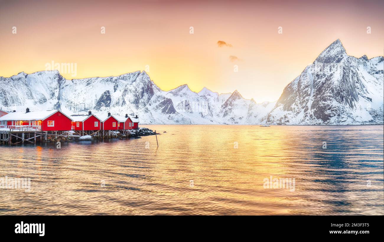 Traditional Norwegian red wooden houses (rorbuer) on the shore of ...
