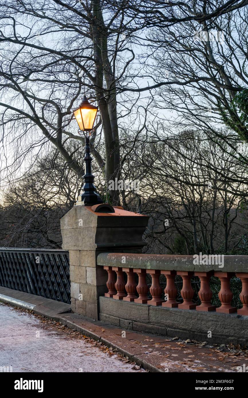 A lit Victorian lamp on Armstrong Bridge, Jesmond Dene, in Jesmond ...