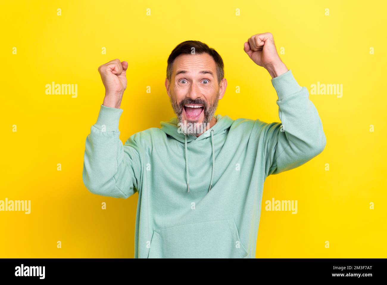 Photo of mature age man grey beard excited screaming fists up hooray ...