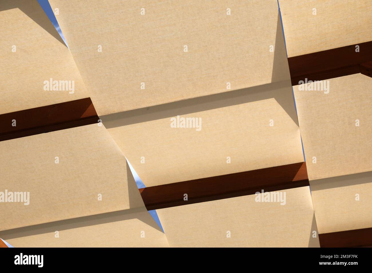summer ceiling of wooden beams and white fabric and blue sky Stock ...