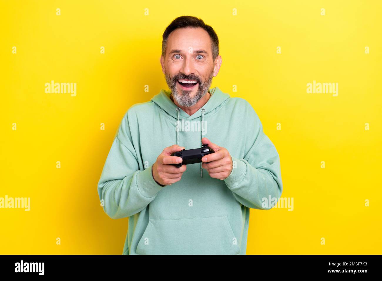 Photo of glad joyful man have free time enjoying playing favorite game ...
