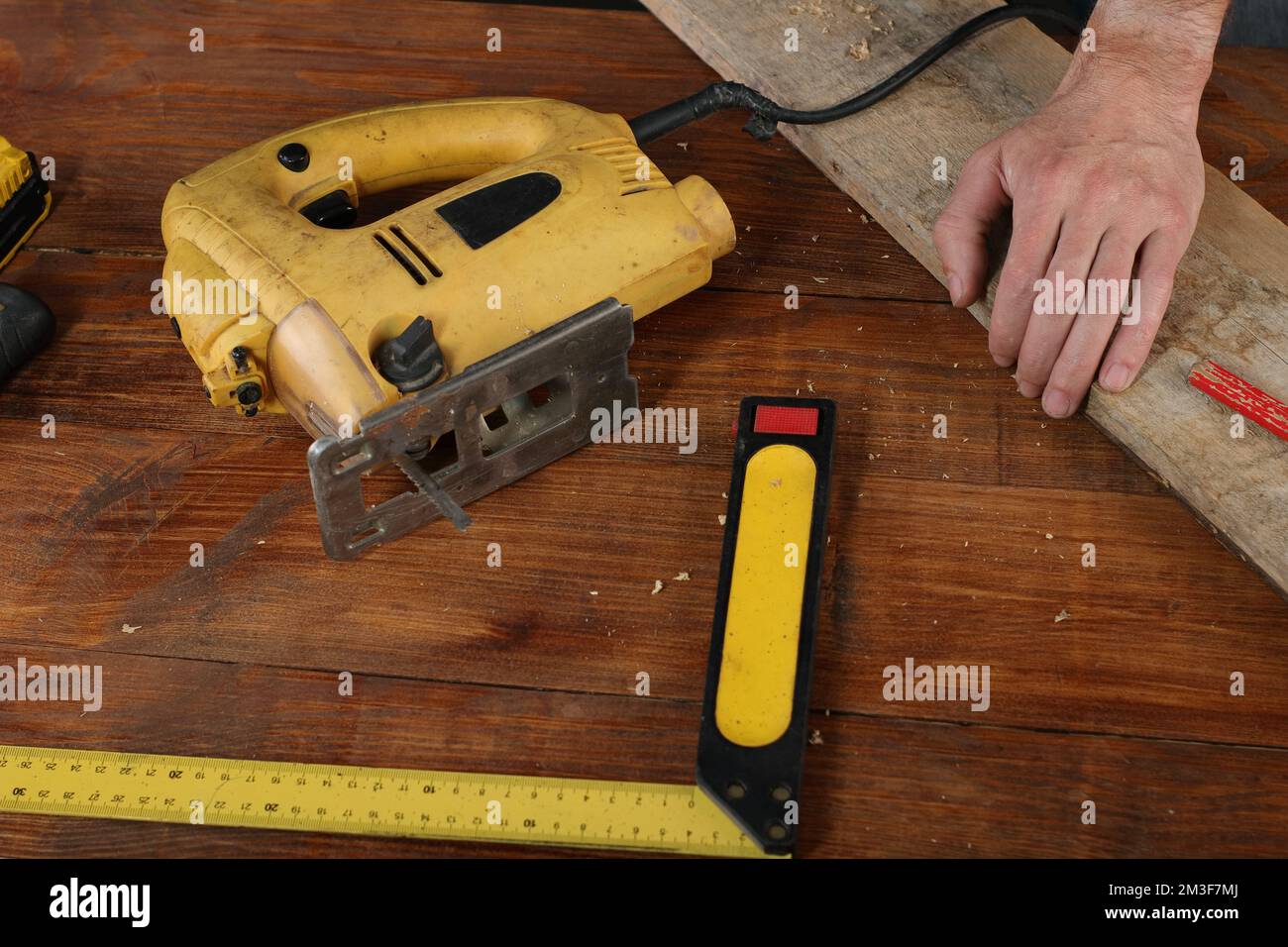 carpentry tools on the table with hand Stock Photo - Alamy