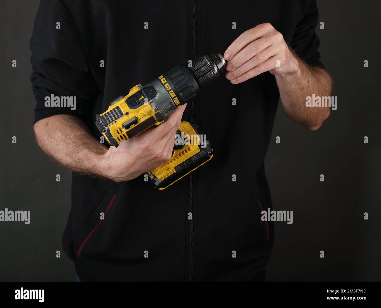 replacement of the tip in the screwdriver by a person on a gray ...