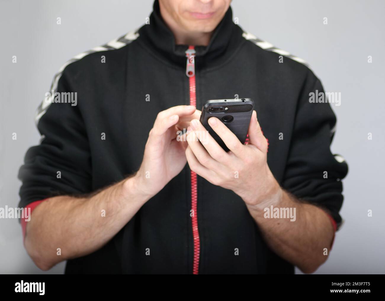 young man writes a text message on a white background Stock Photo - Alamy