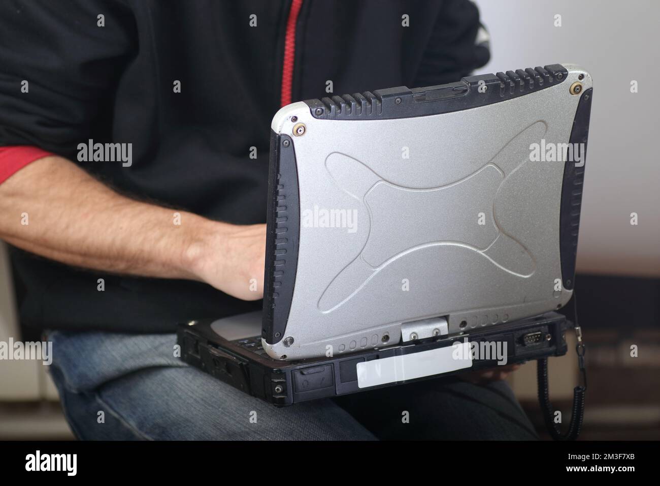 used gray laptop on man's lap Stock Photo - Alamy