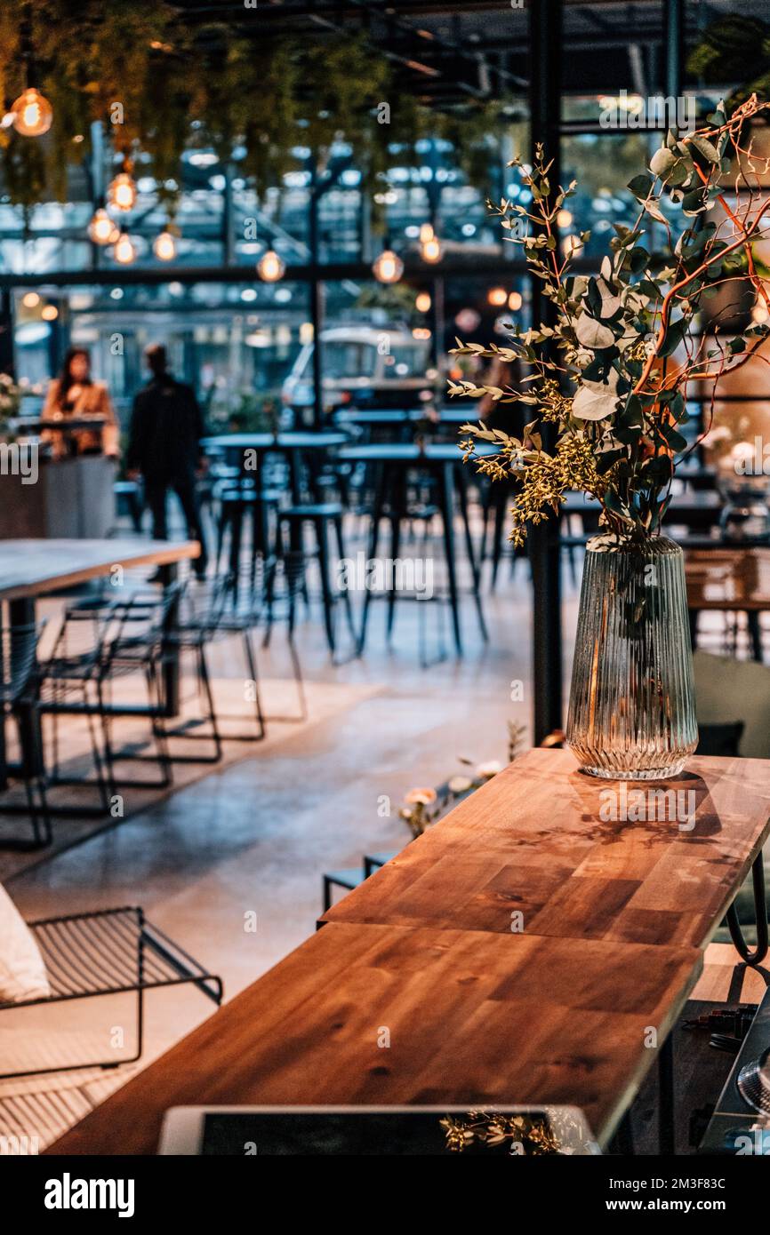 A vertical shot of an empty restaurant table with a flower vase Stock ...