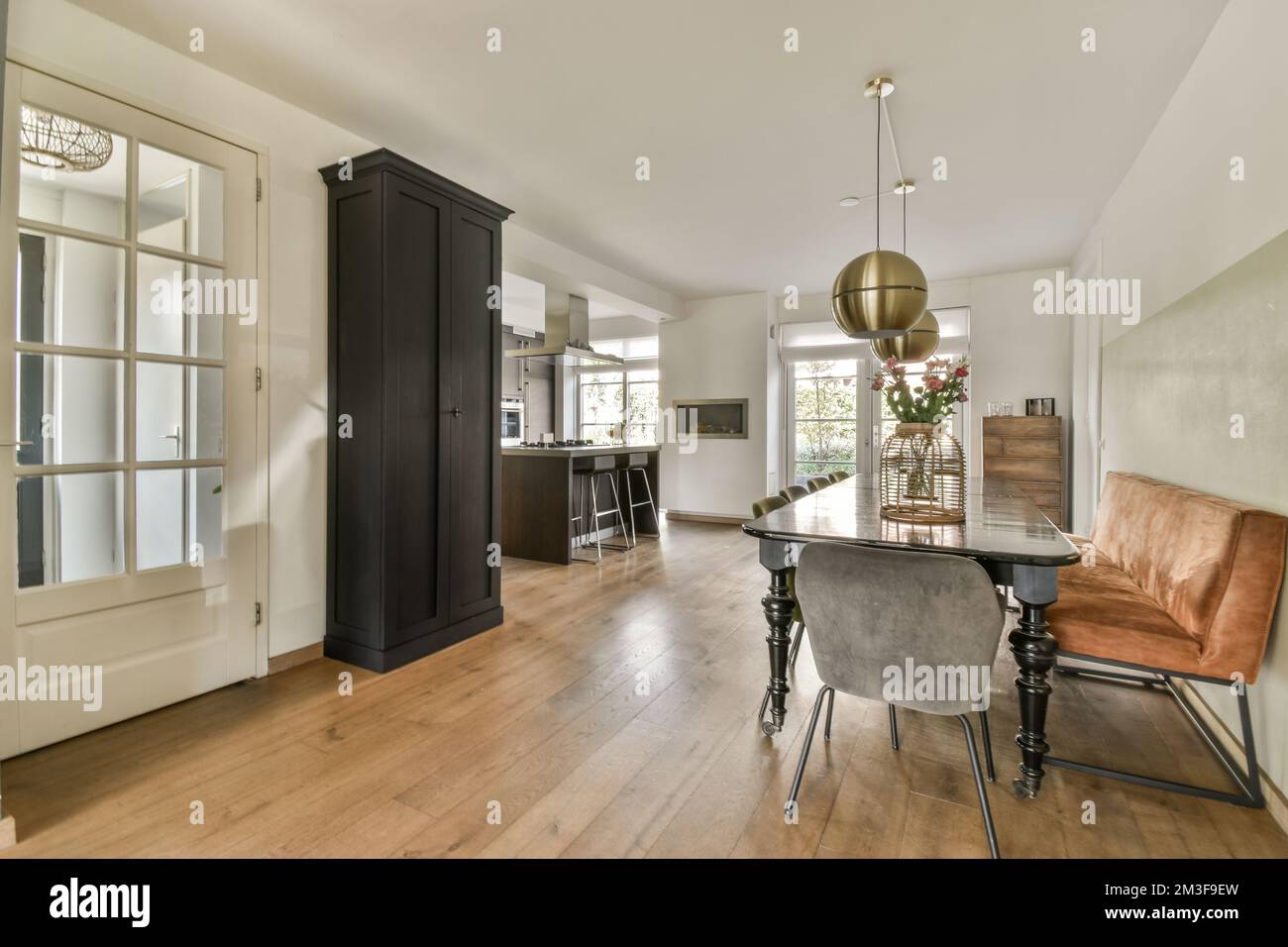 Table with chairs near lounge area and kitchen in spacious room of ...