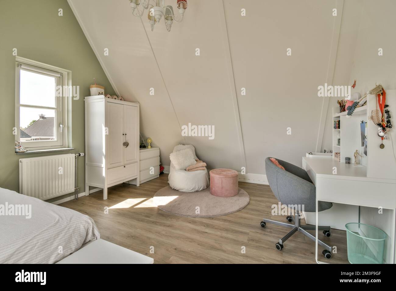 Mansard interior of bedroom with parquet floor and white walls ...