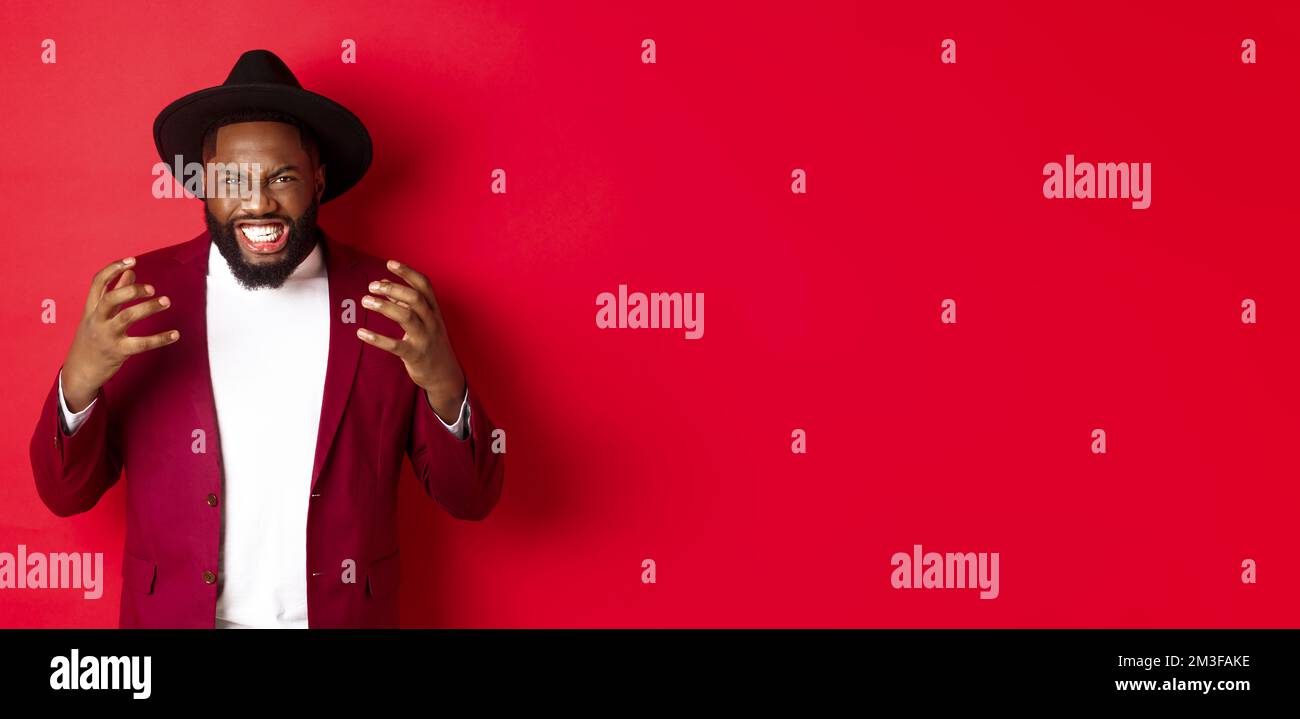 Angry african american man looking aggressive, shaking hands and ...