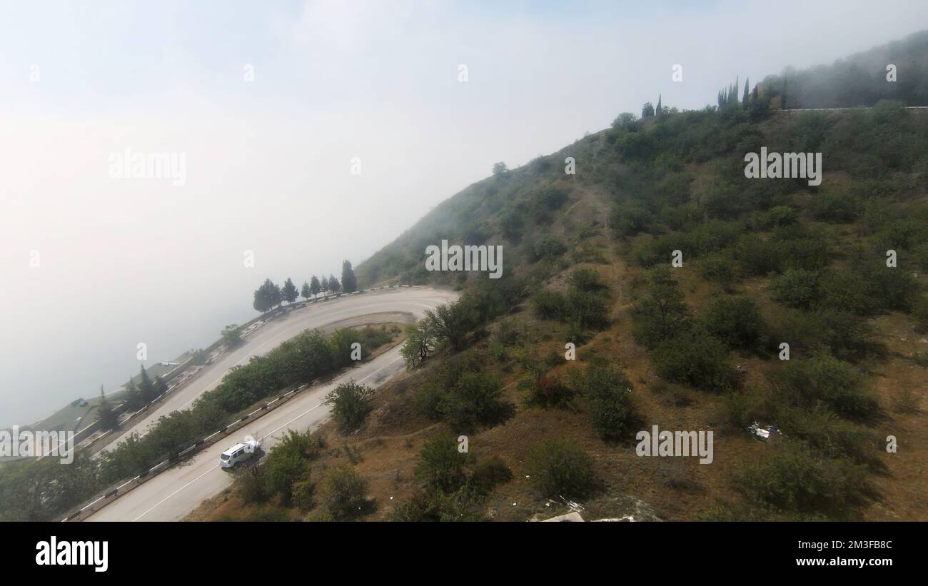 A long road on the mountain. Shot.A long track for cars is located on a ...