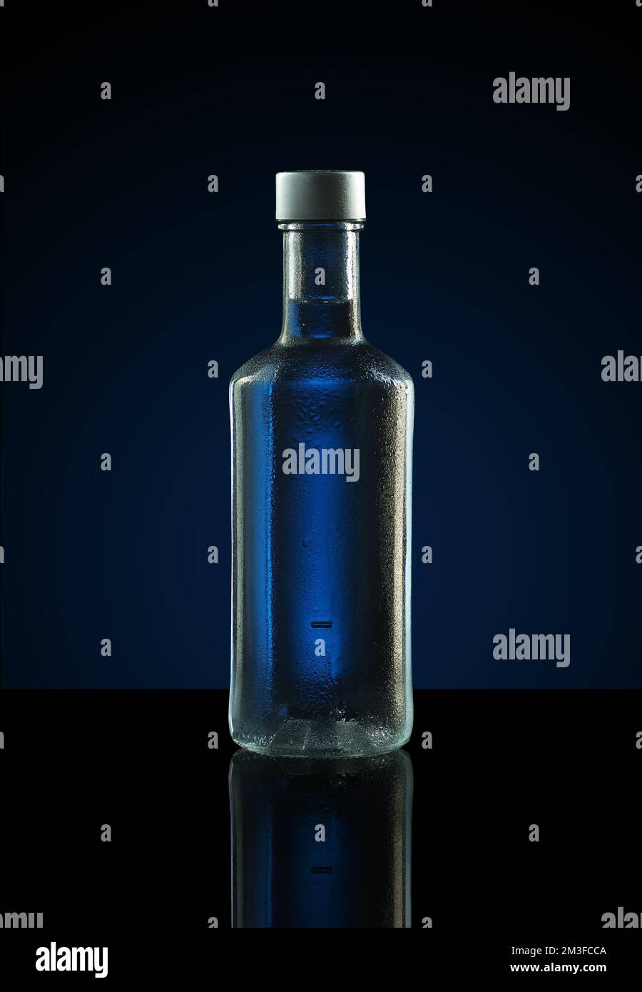 bottle of pure vodka on a background of a gradient and a mirror reflection Stock Photo - Alamy