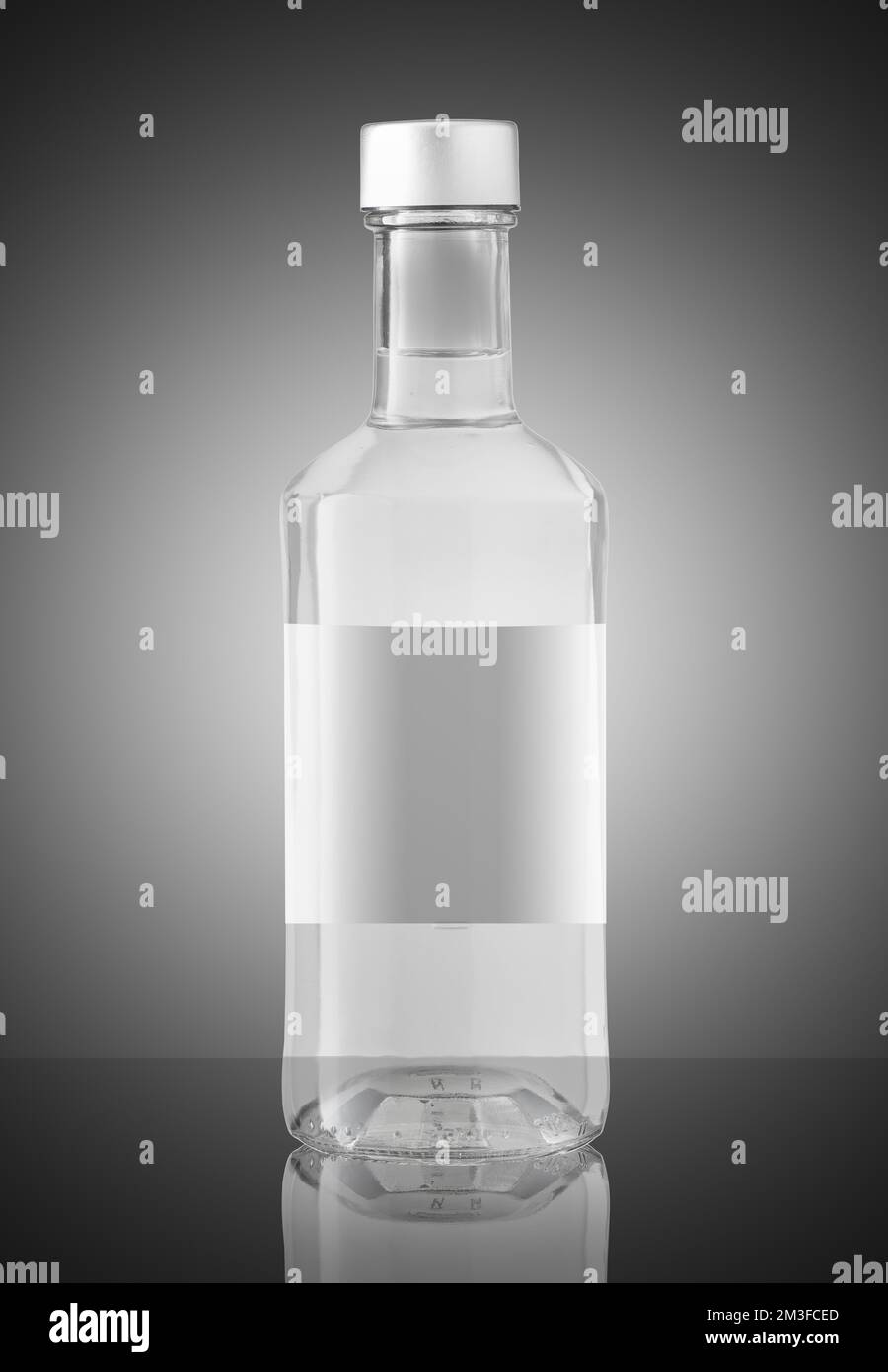 glass bottle of vodka on gray background with gradient Stock Photo - Alamy