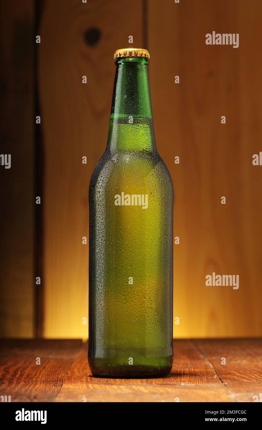 green glass bottle with beer in drops on wooden background Stock Photo ...