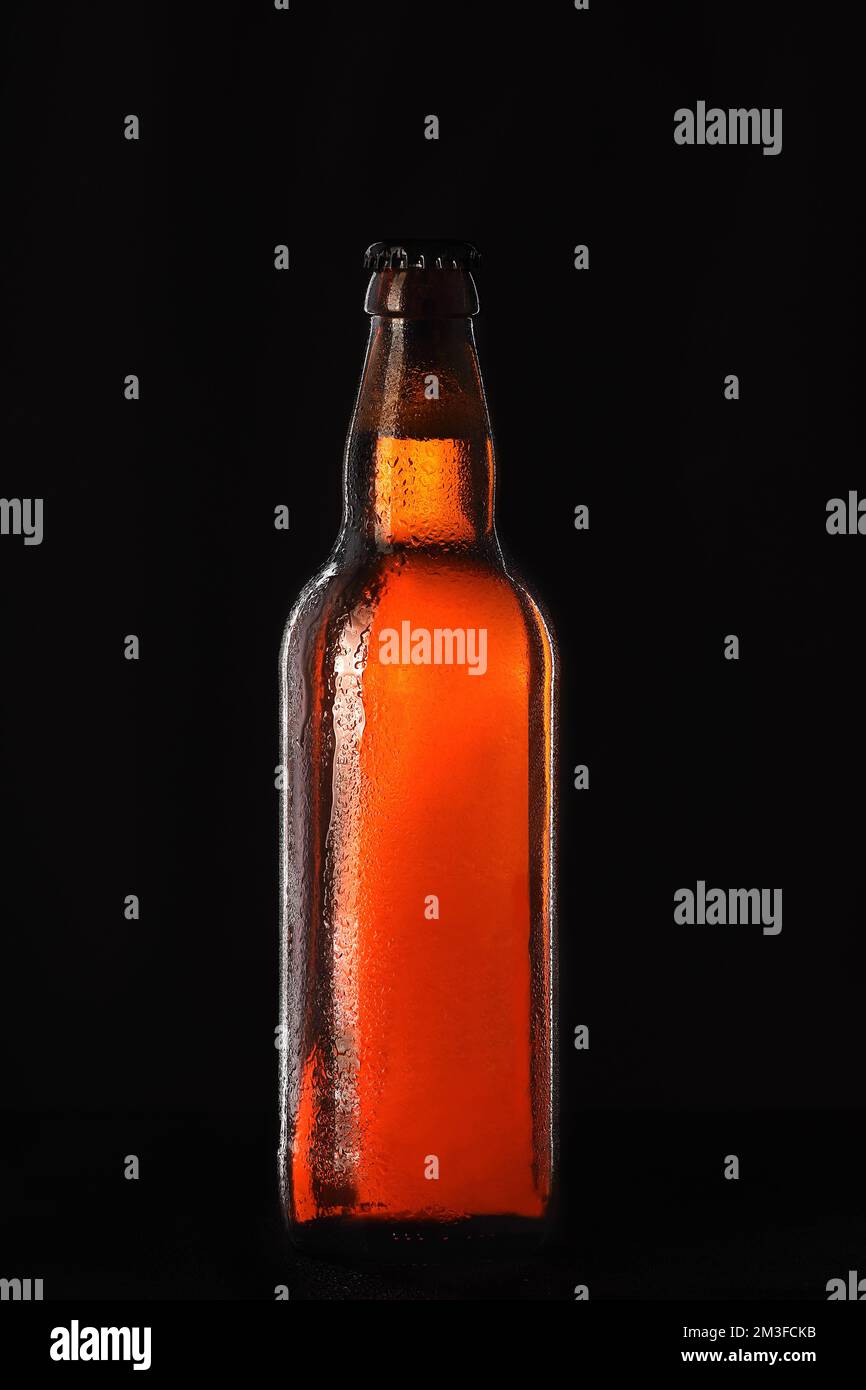 full glass bottle of beer on a black background Stock Photo - Alamy