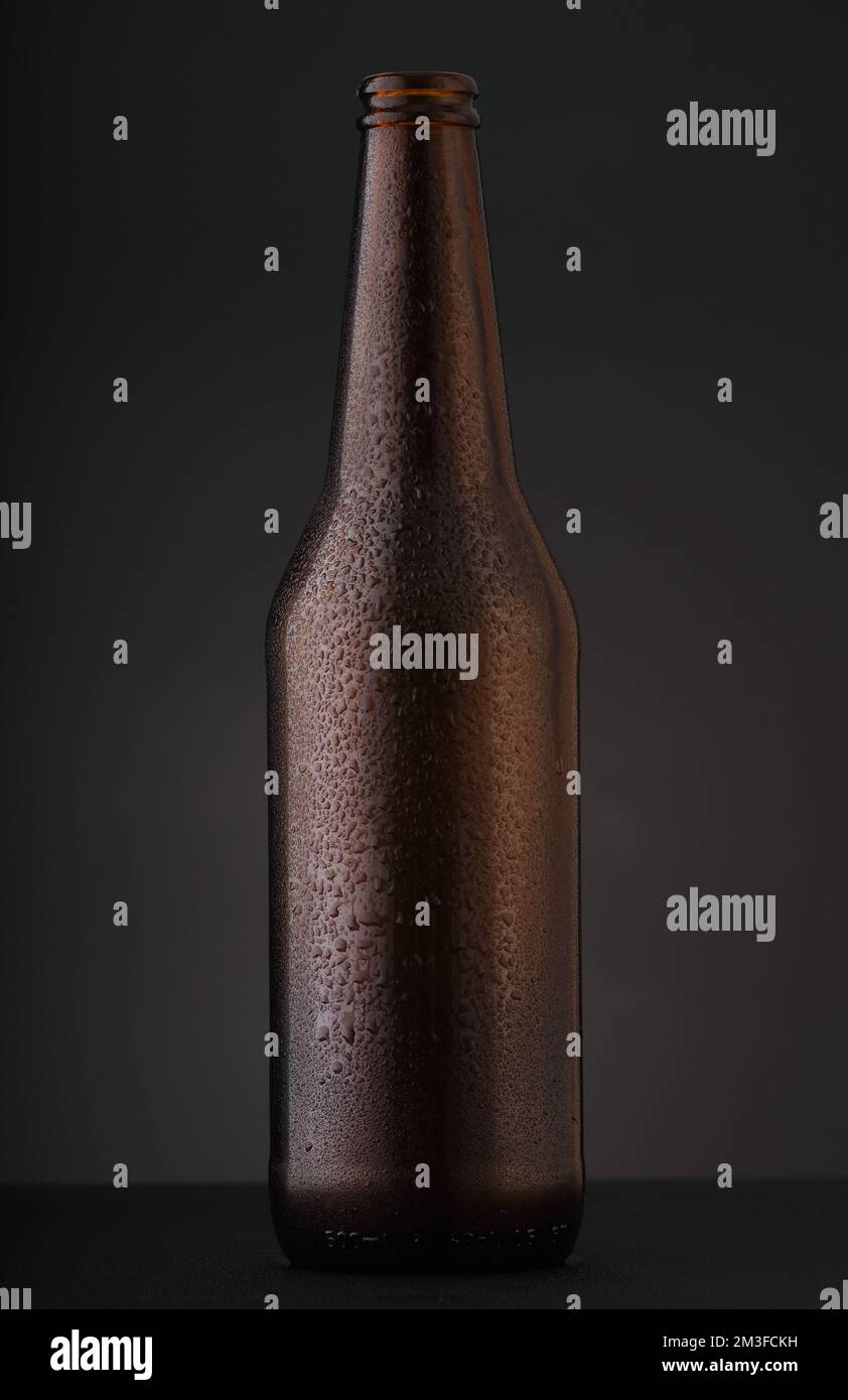 brown beer bottle on black background Stock Photo - Alamy