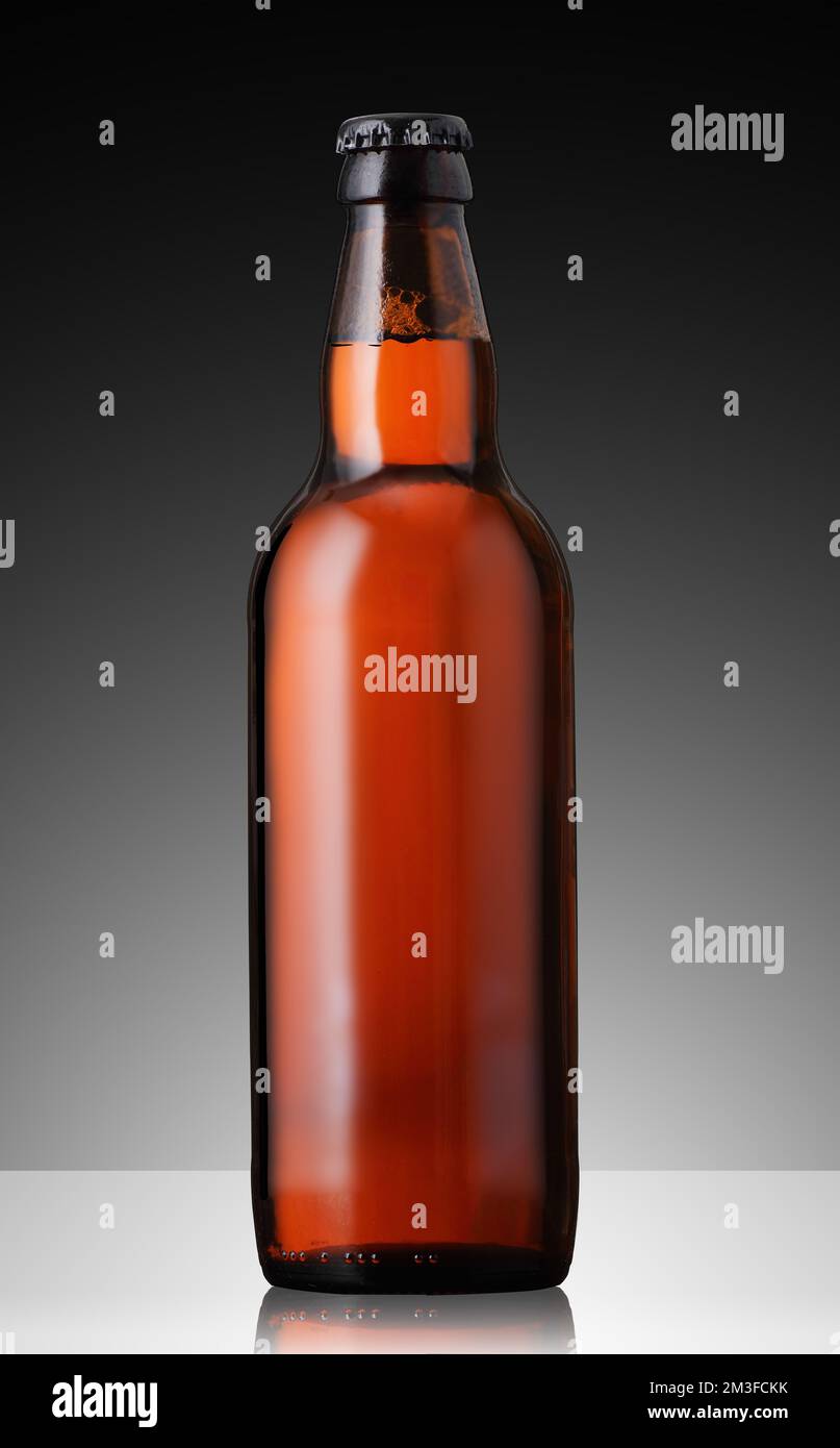 brown full beer bottle on gray gradient background Stock Photo - Alamy