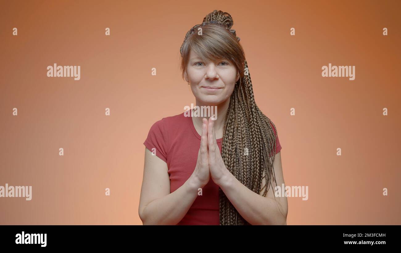 Woman greets with folded hands. Action. Yoga greeting with gratitude ...